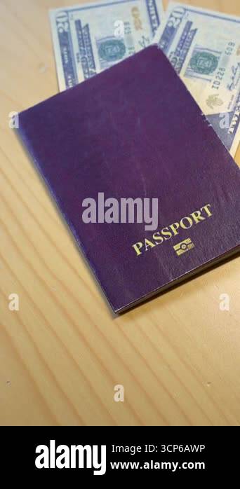 Purple passport with twenty dollar bills tucked inside, suggesting ESTA ...