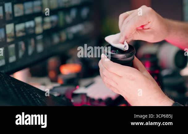 Photographer cleaning lens desk setup editing workspace. Close-up of a ...
