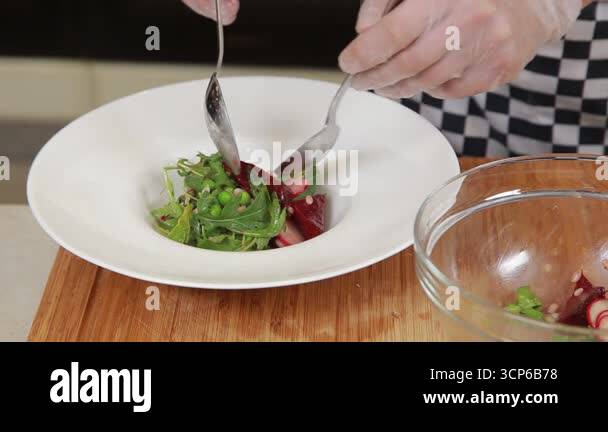 Chef is cooking salad with beetroot and radish Stock Video Footage - Alamy