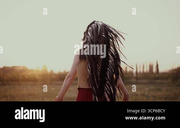 A figure adorned with an elaborate Native American-style headdress ...