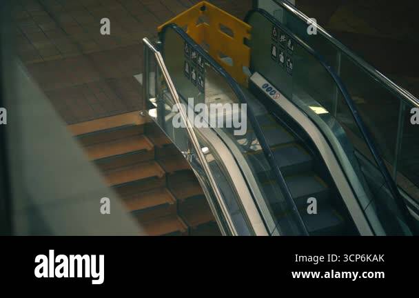 Escalator moving staircase in shopping mall wide top view 4k shot selective focus Stock Video ...
