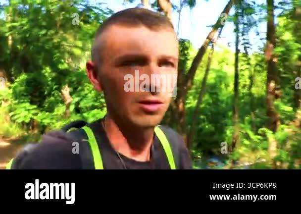 Handsome male tourist man at tropical jungle and forest hiking trails ...