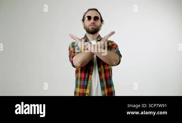 Man in colorful shirt and sunglasses crosses arms to signal no or stop ...