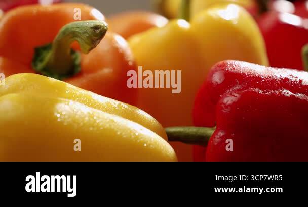 A vibrant close-up image of fresh, colorful bell peppers in red, yellow ...