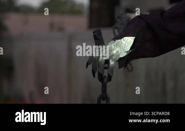 Close-up of a creepy Halloween ghoul hand with long claws gripping a ...