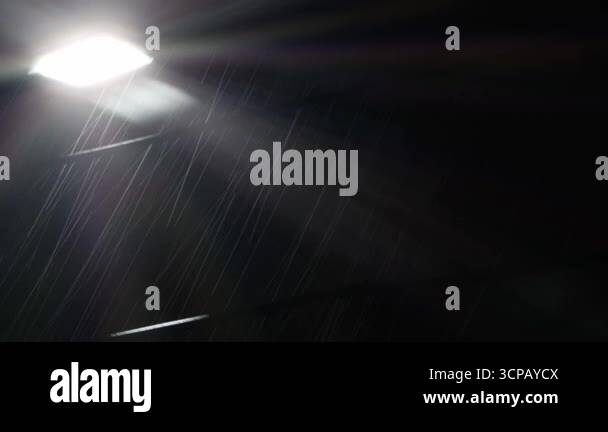 Night rain. Street Light glowing in the dark while rain falls at night ...