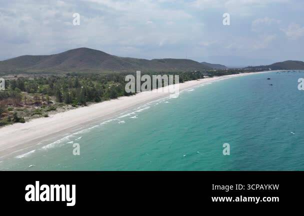 Aerial view of the endless white sandy shoreline of Doc Let beach ...