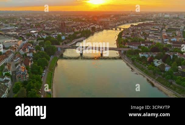 Aerial drone footage of the Basel old town along the Rhine river which ...
