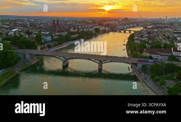 Aerial drone footage of the Basel old town along the Rhine river which ...