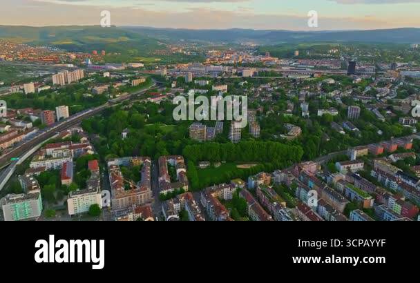 Aerial drone footage of the Basel old town along the Rhine river which ...