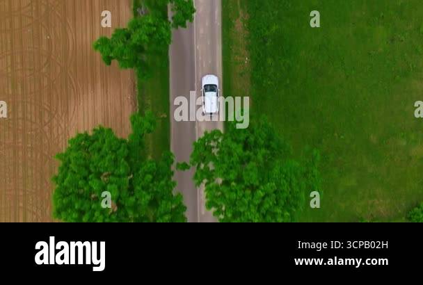 Aerial view Electric Car Driving on Country Road. Luxury modern vehicle riding fast along trees ...