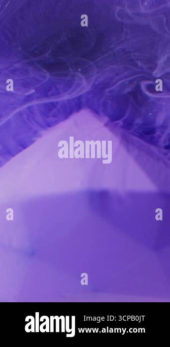 Vertical video. Paint spill. Vapor texture. Purple liquid flow swirl ...