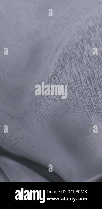 Vertical video. Ripple flow. Liquid ink. Defocused gray black chemical ...
