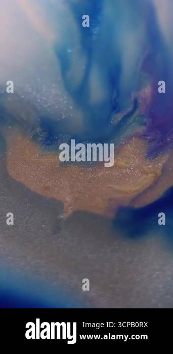 Vertical video. Marble texture. Sparkling liquid. Defocused blue yellow ...