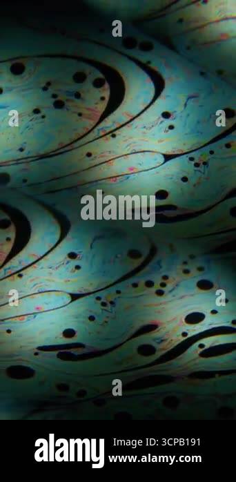 Vertical video. Gasoline fluid. Kaleidoscope oil. Color duplicated ...
