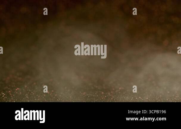 Paint fume. Glitter mist. Defocused bronze color water shimmer vapor ...