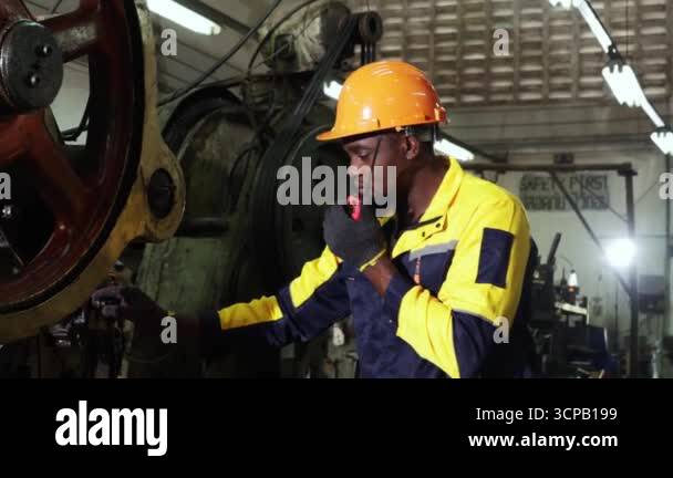 African American male worker technician wearing safety helmet stops ...
