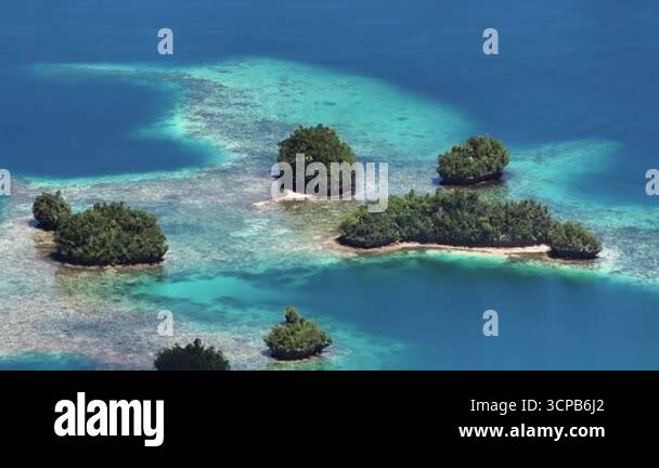 Cluster of tropical islets with turquoise ocean water and corals ...