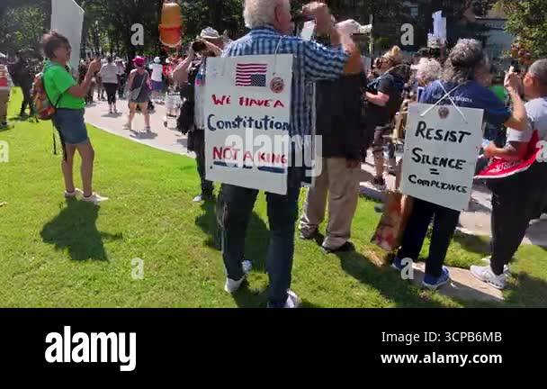 Atlanta, GA / USA September 1, 2025: Tracking shot shows man wearing ...