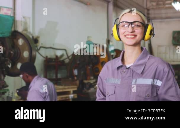 Female factory lathe operator worker in automotive parts manufacturing ...
