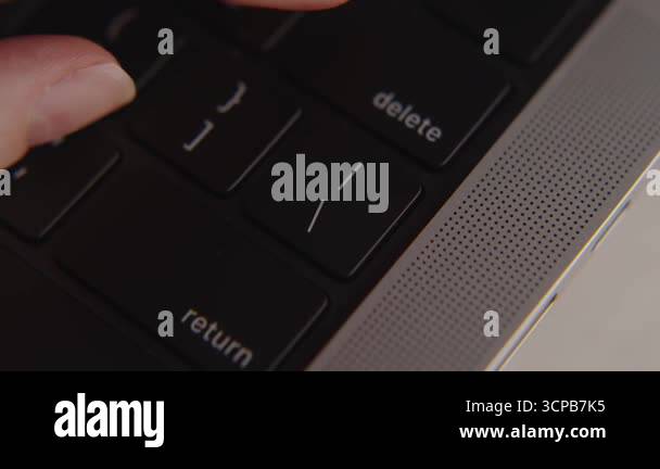 Close-up of a person pushing delete button, symbolizing data removal ...