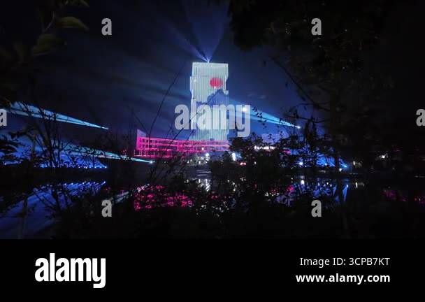 Colorful beams light up a modern tower during the Mid Autumn Festival ...