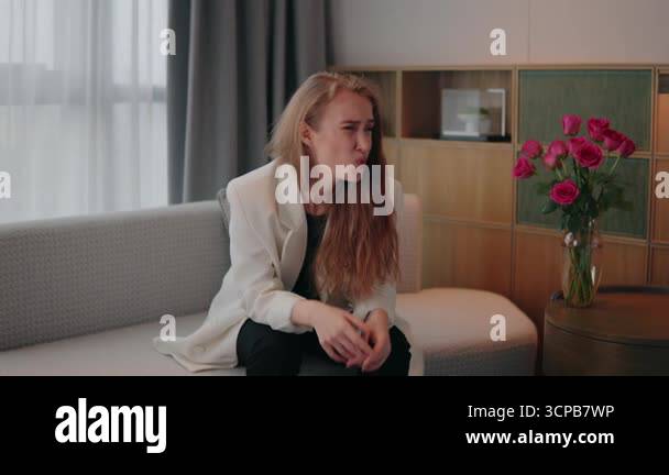 Upset young woman shouting and crying alone at home, feeling stressed ...