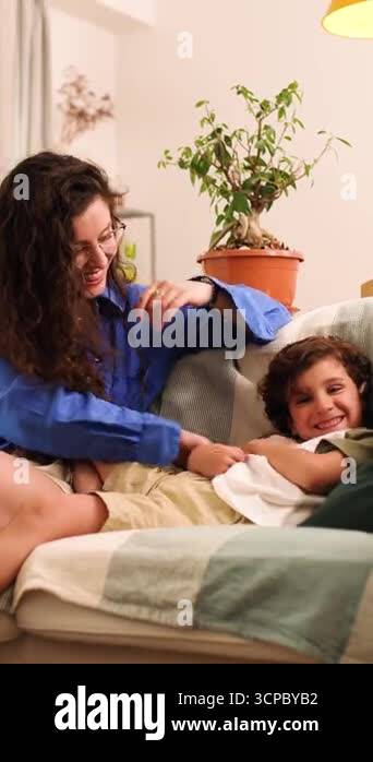 Warm mother-son connection, playfully tickling and laughing together on ...