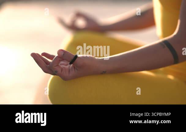 Close-up of female hands performing gyan mudra gesture during outdoor ...