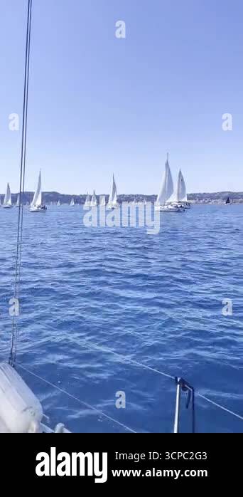 Vertical video captured from the bow of a moving sailing yacht just ...