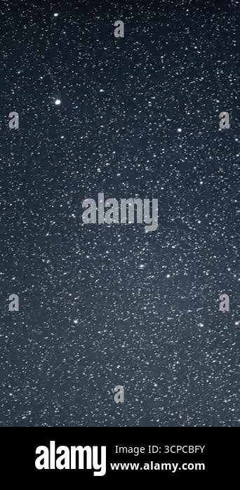 Vertical time-lapse of a dense starfield drifting across a dark starry ...