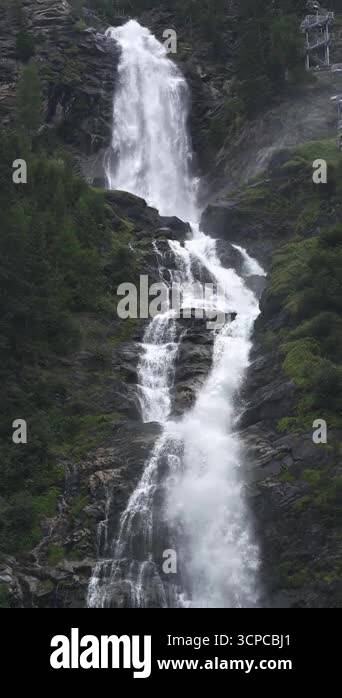 Vertical clip of the Stuibenfall in the Alps: a towering cascade ...