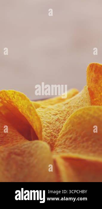 Finger Food Chips Rotating in Macro Frame with Salted Texture Vertical ...