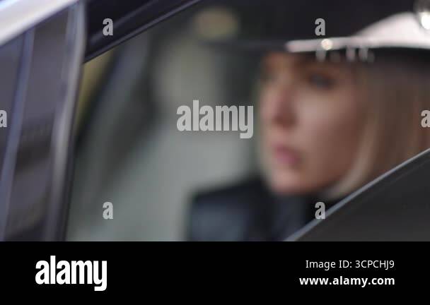 Close up of a female detective in hat and leather gloves taking photos ...