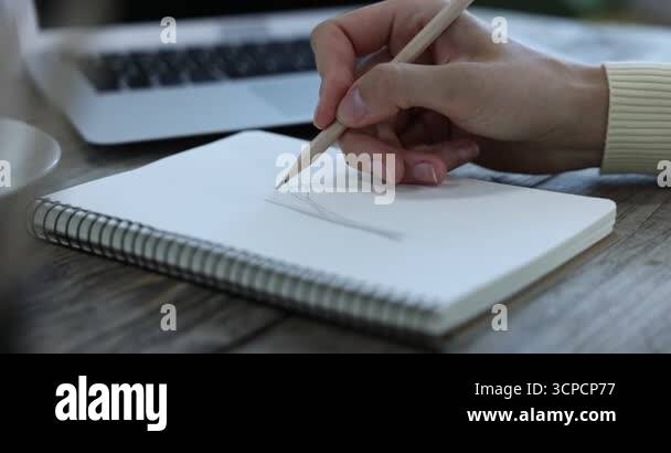 Woman drawing sketch at wooden table, closeup Stock Video Footage - Alamy