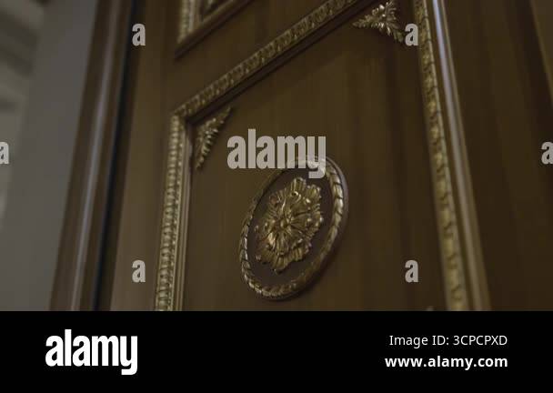 Wooden panels decorated with golden rectangular ornaments glow with ...