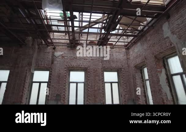 Partially dismantled ancient building reveals fragile beams. Open sky ...