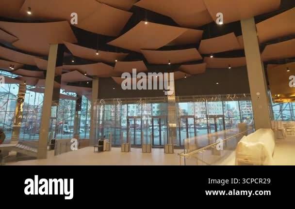 Panoramic foyer filled with decorative ceiling panels shines ...