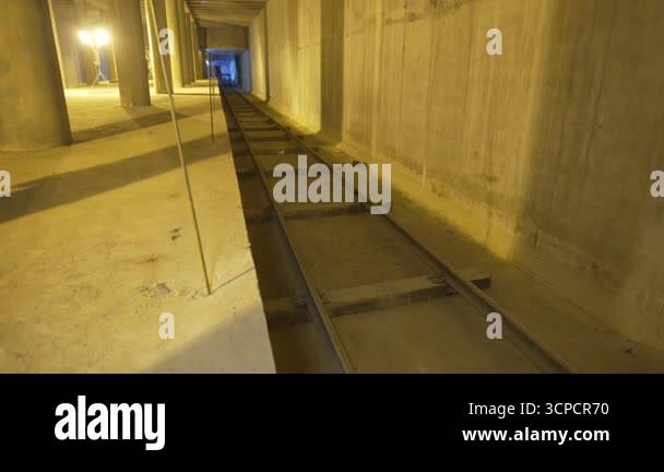 Sparse sleepers rest inside rough trench awaiting assembly. Human ...