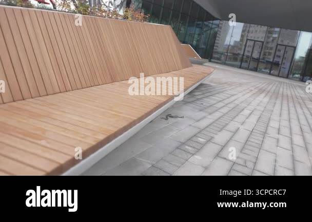 Modern square decorated with sleek benches welcomes visitors. Modern ...