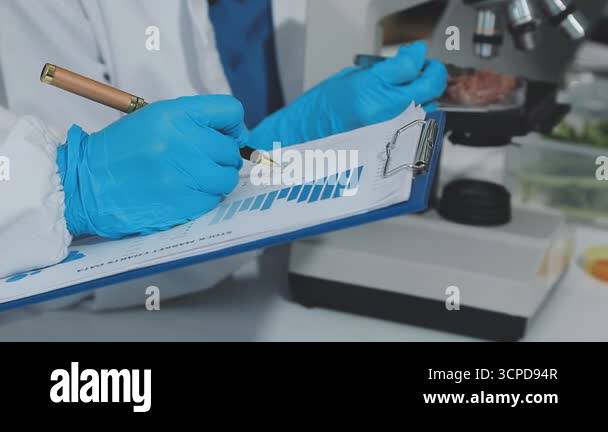laboratory assistant in blue coat holding a pipette in the laboratory ...