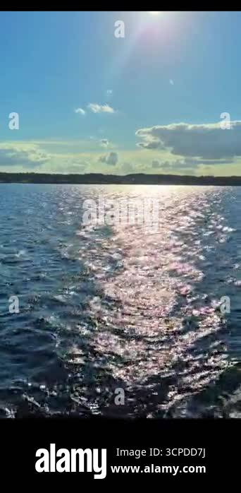 The glistening surface of the water reflects the beautiful sunlight ...