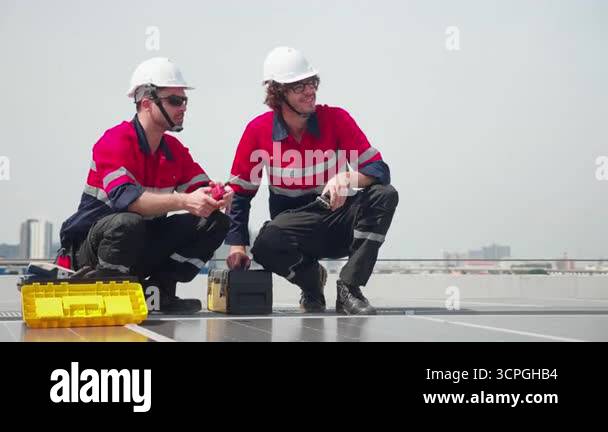 Team engineer and technician working on solar panel installation at ...