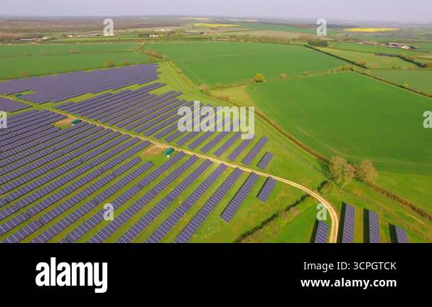 Aerial view of large solar panel arrays on a solar farm on adapted ...