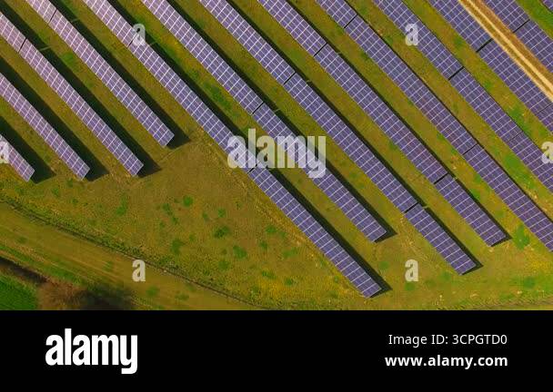 Aerial view of large solar panel arrays on a solar farm on adapted ...