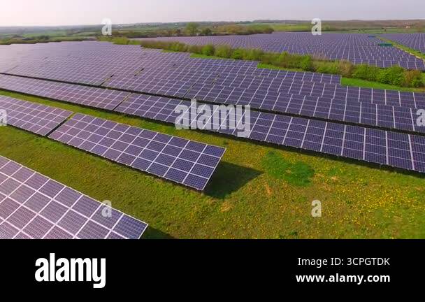Aerial view of large solar panel arrays on a solar farm on adapted ...