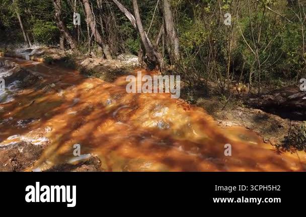 Flowing lime from a pipe and acid mine drainage reaction, water ...