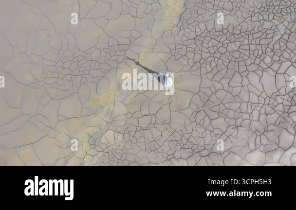 Fast forward aerial view of a sinking church in a decanting lake, tower ...