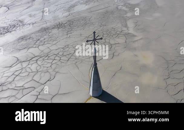 Surreal aerial view of sinking church in a decanting lake, tower with ...