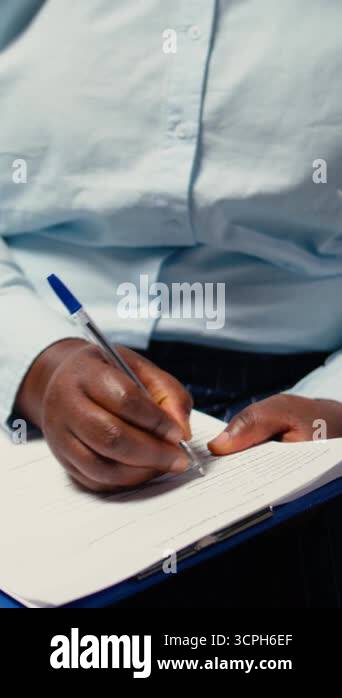 Vertical Video Close up of candidate filling in registration forms for ...